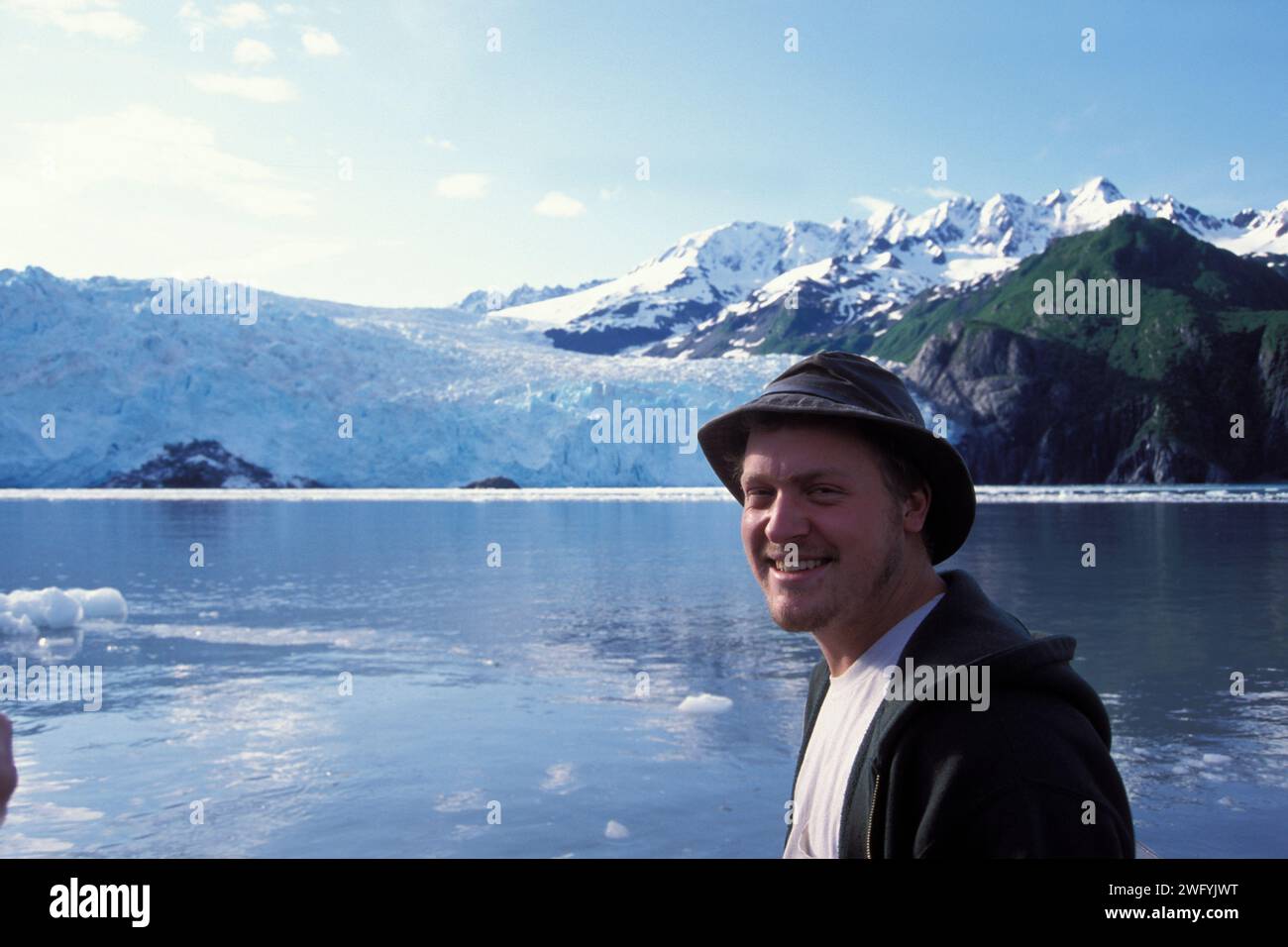 tourboat deckhand Paul in front of Ailak bay, Ailak glacier, Kenai ...