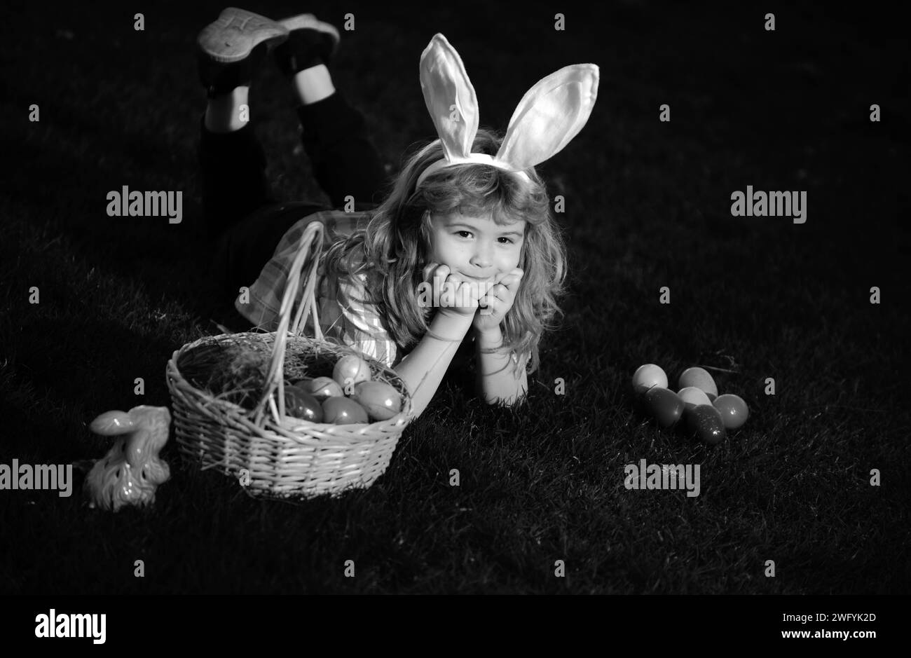 Cute bunny child with rabbit ears. Child with easter eggs in basket ...