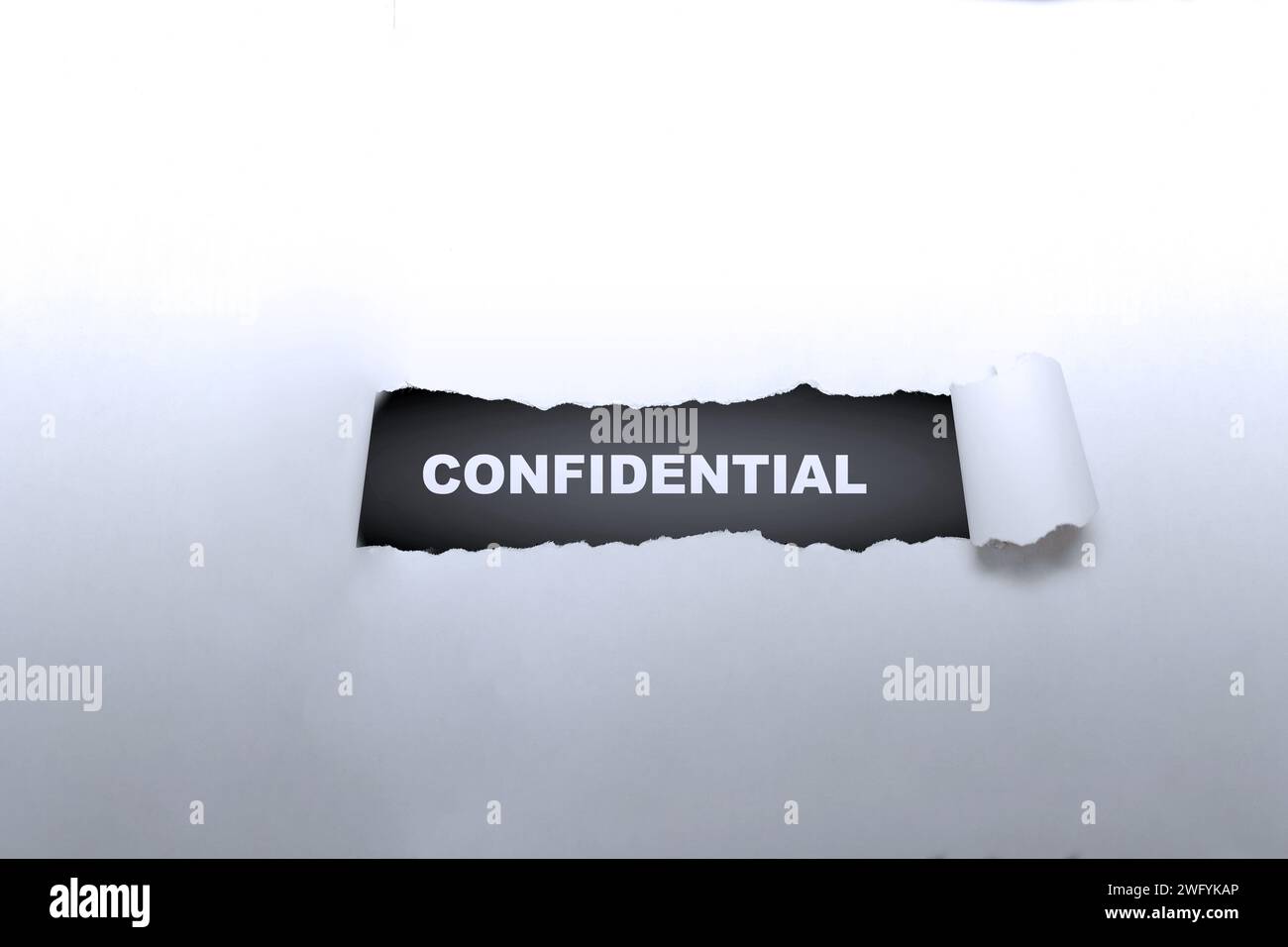 Ripped paper with confidential text over a black background. Secret ...