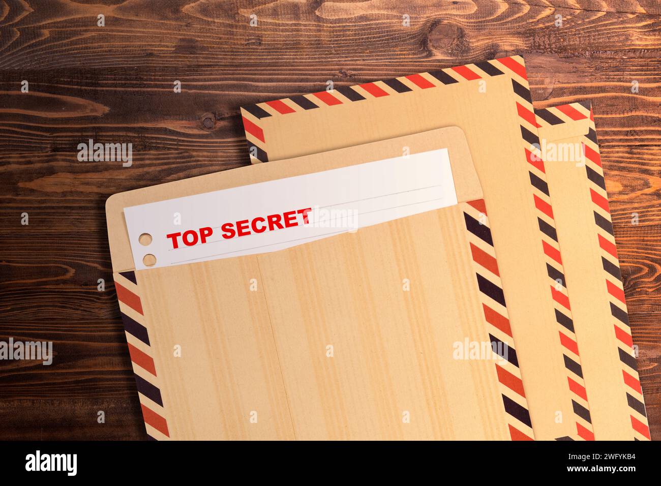 Opening a brown envelope with the text of top-secret on the paper ...