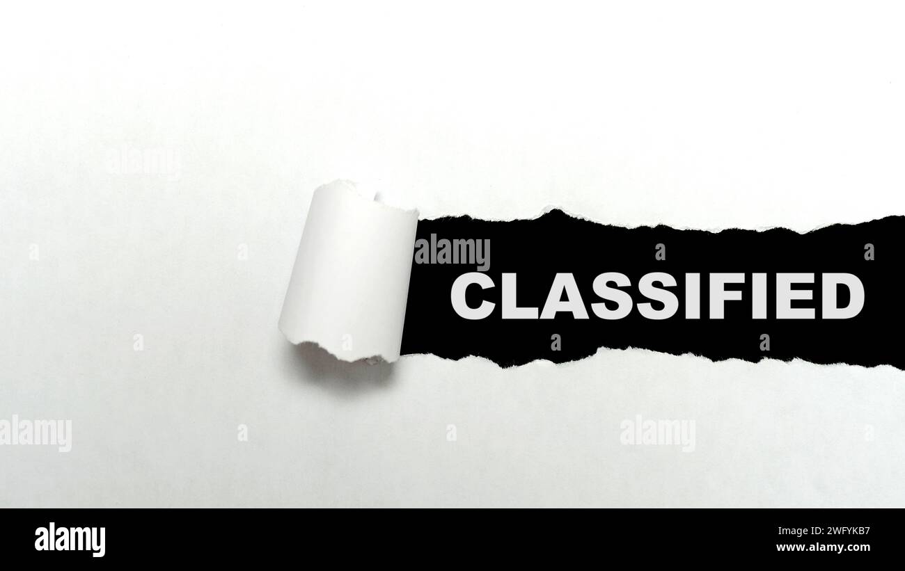 Ripped paper with classified text over a black background. Secret ...