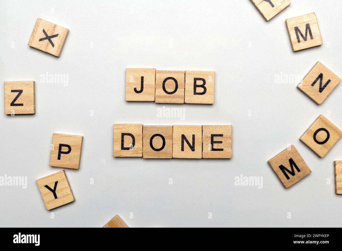 A row of wooden cubes with job done text over a white background ...