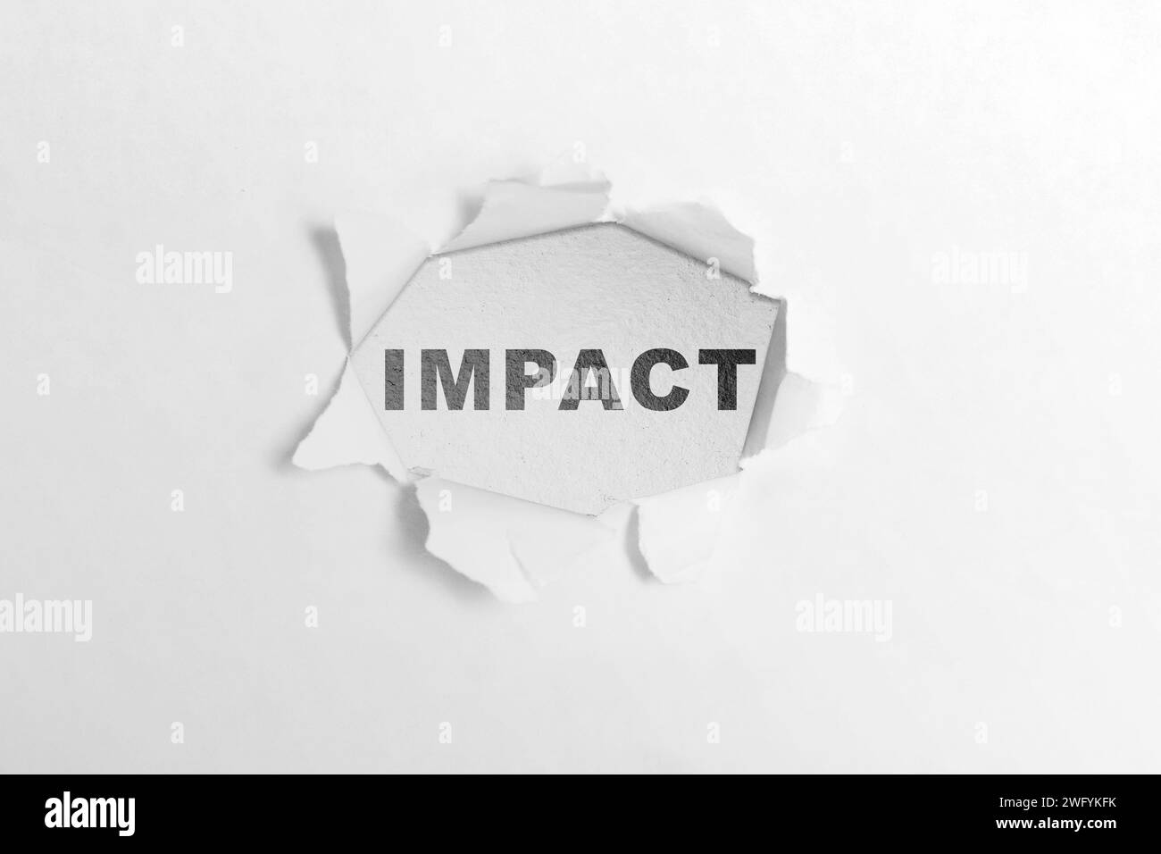 Ripped paper with impact text over a white background. Business impact ...