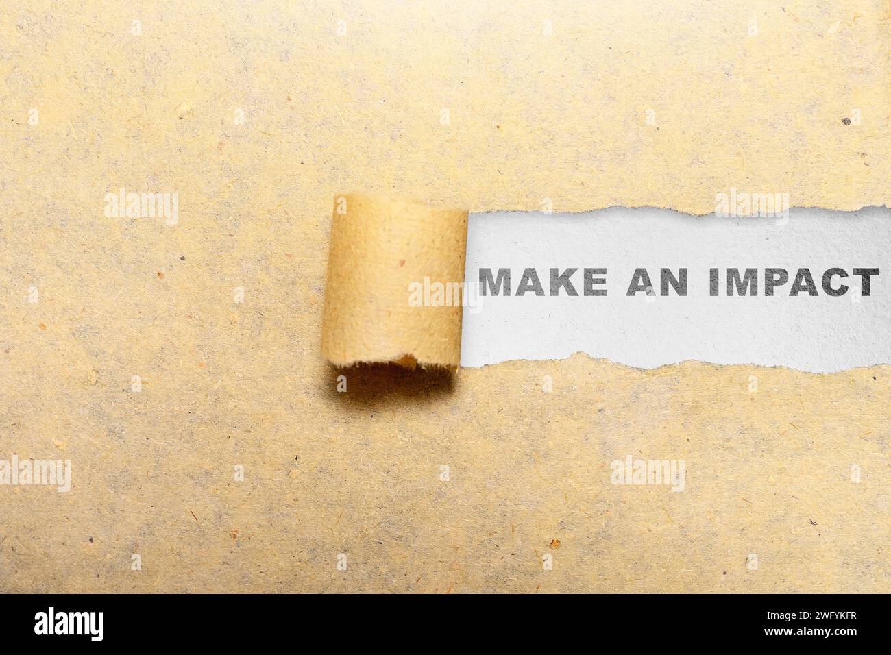 Ripped paper with text of make an impact over a white background ...