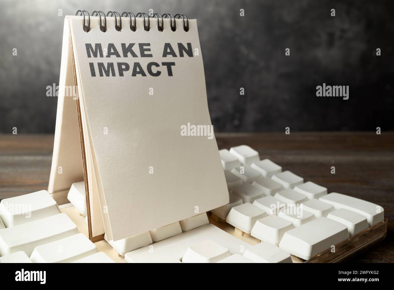 Notes with text of make an impact on the keyboard. Business impact ...