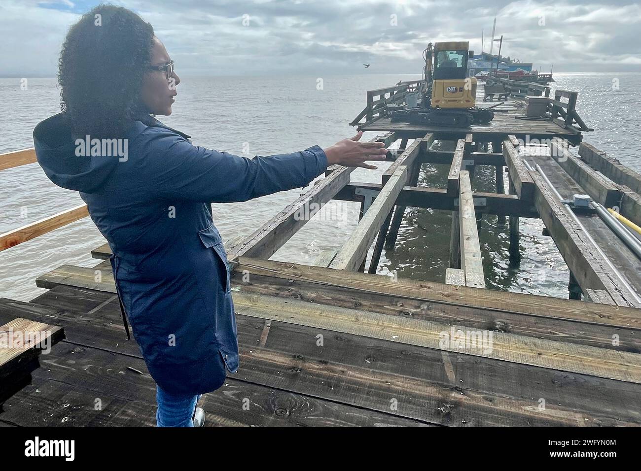 Capitola Public Works Director Jessica Kahn gestures toward a damaged ...