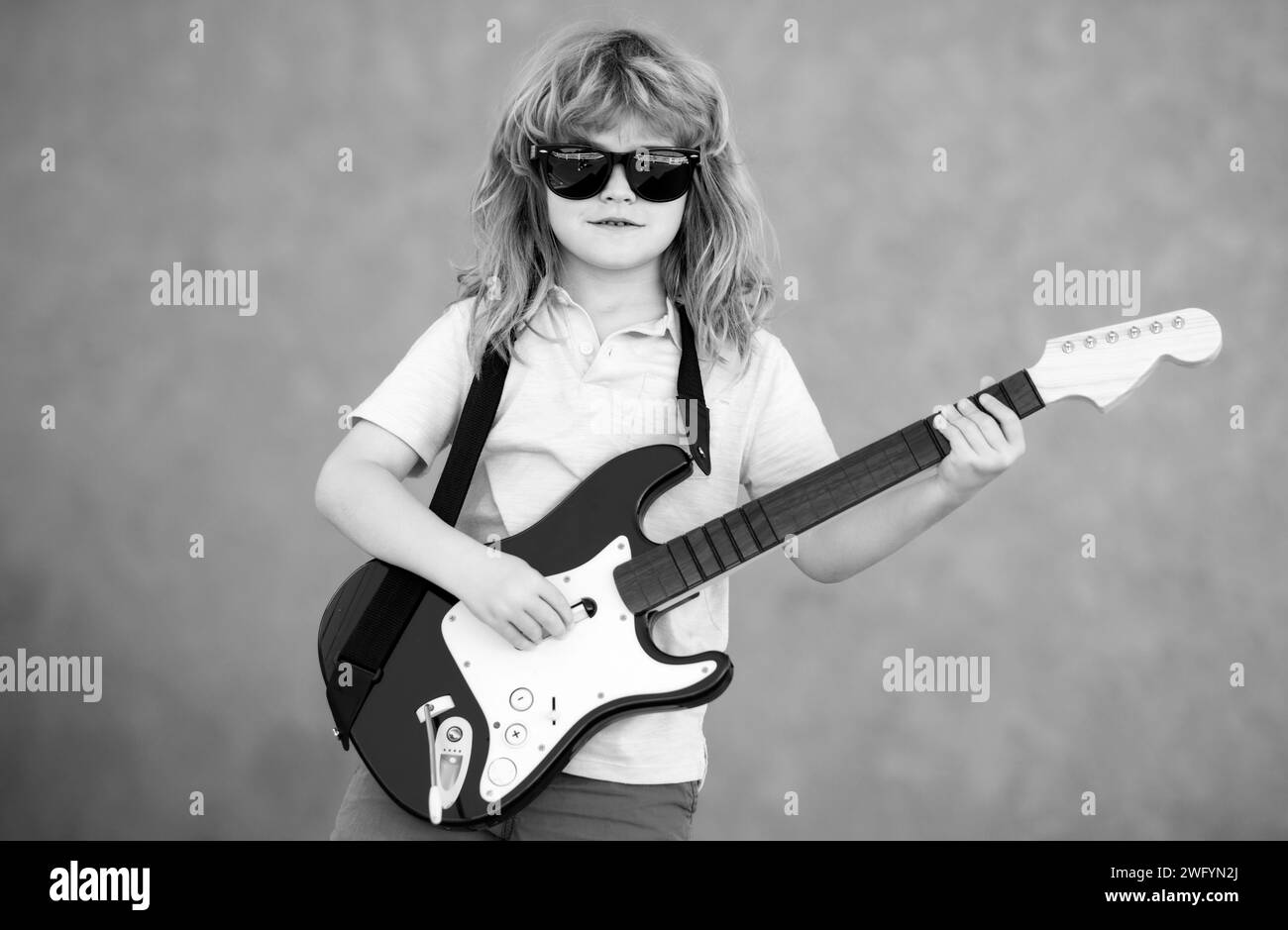 Child musician guitarist playing electric guitar. Music kids Stock ...
