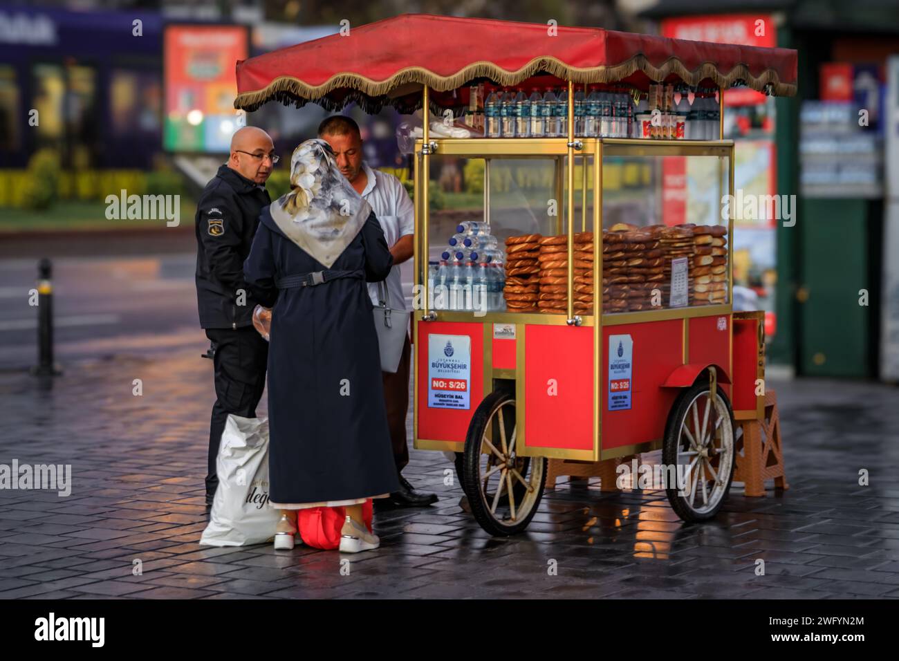 Istanbul, Turkey - November 8, 2023: Customers at the mobile simit cart ...