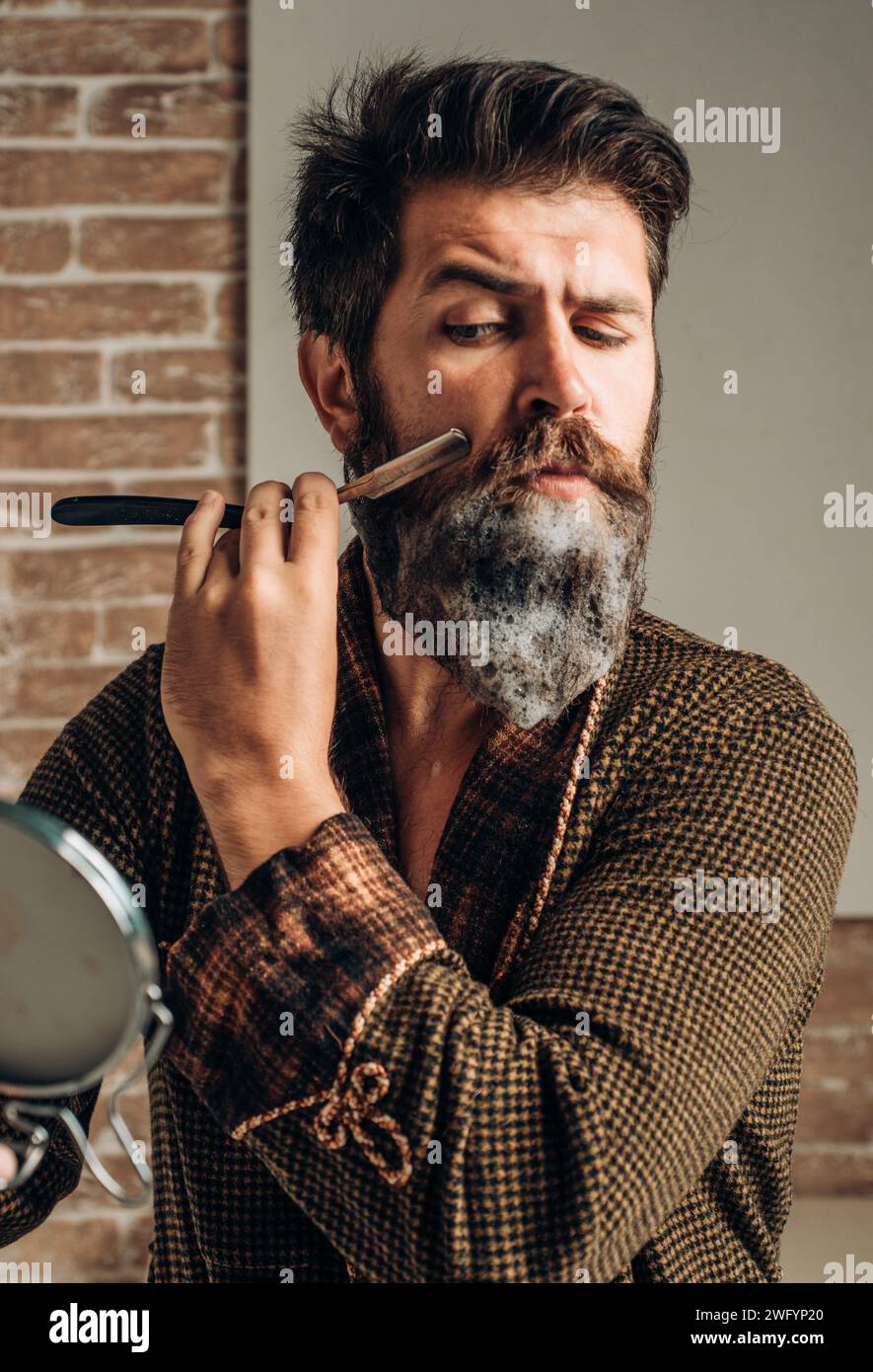 Man visiting hairstylist in barber shop. Trims. He is doing styling ...