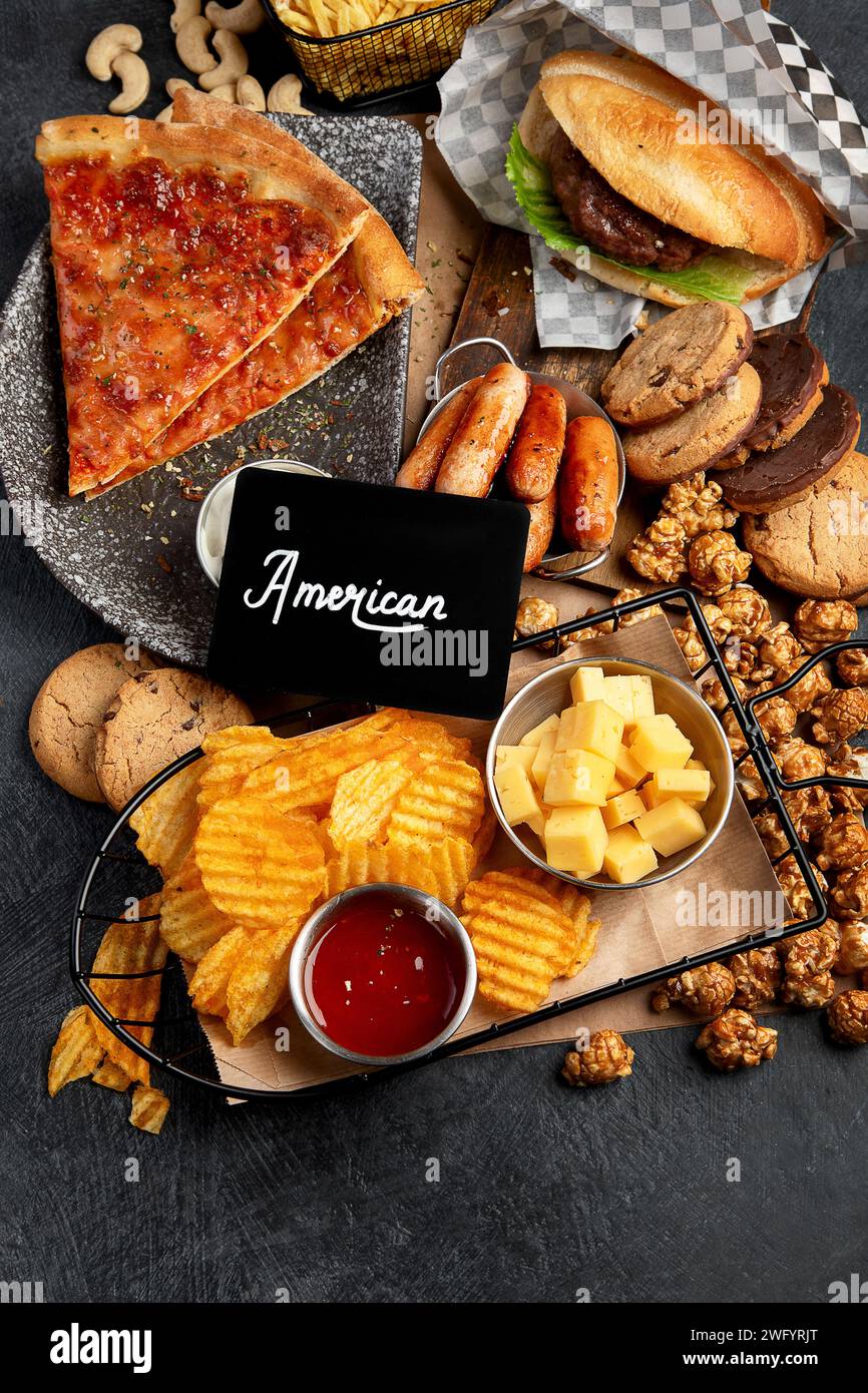 Fast food on a dark background. Junk food for your heart and skin ...