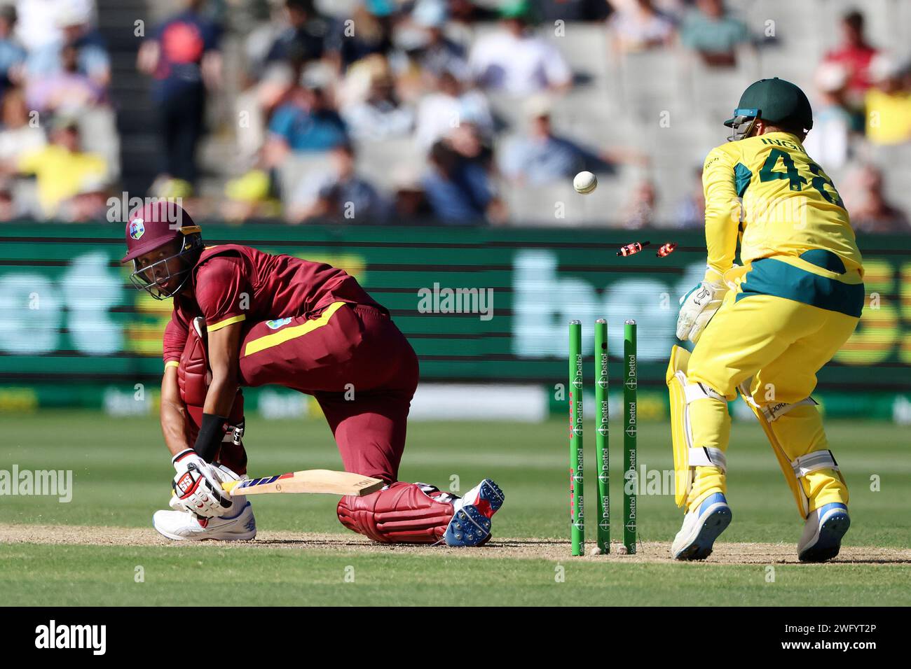 West Indies' Roston Chase, left, is bowled out as Australia's Josh ...