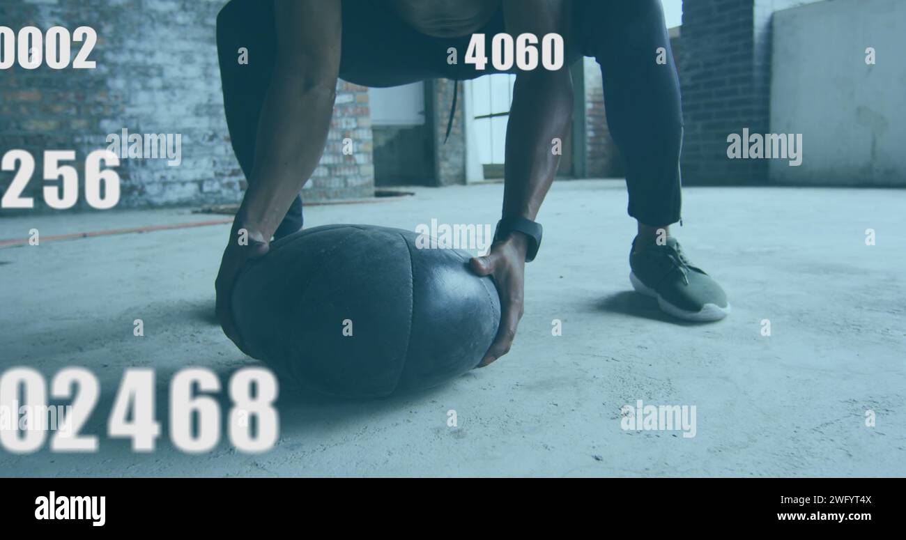 Image of floating numbers over man exercising with a ball Stock Photo ...