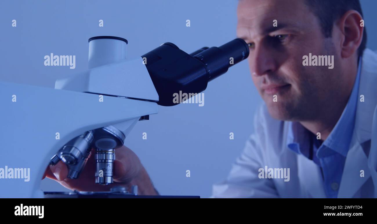 Image of data processing over caucasian male scientist using microscope Stock Photo - Alamy