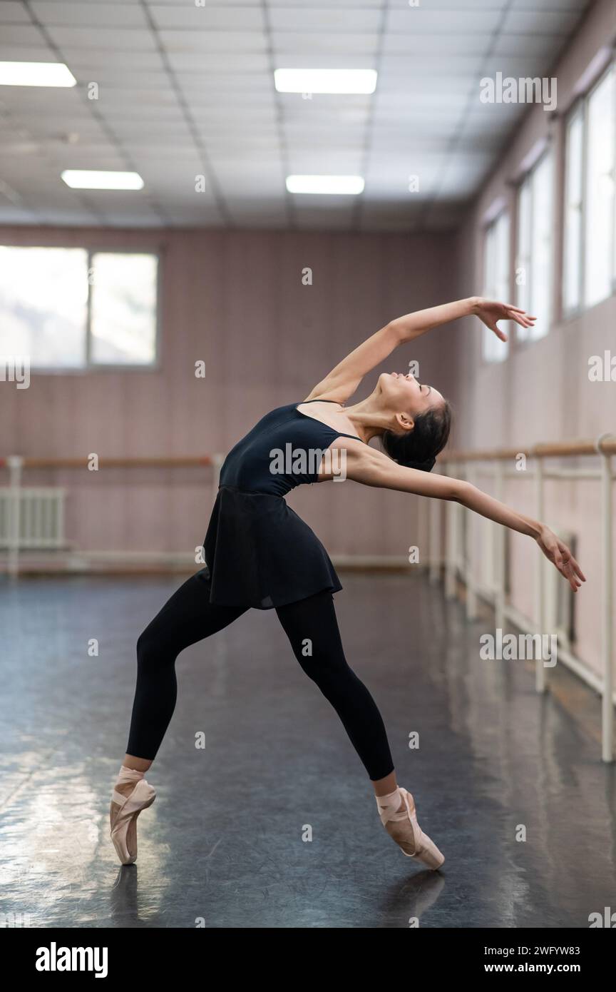 Asian woman dancing in ballet class. Bending in the back Stock Photo ...