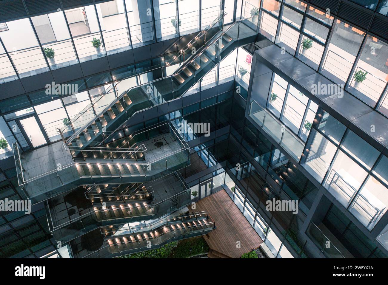 The courtyard garden of a high-tech company with transparent glass ...