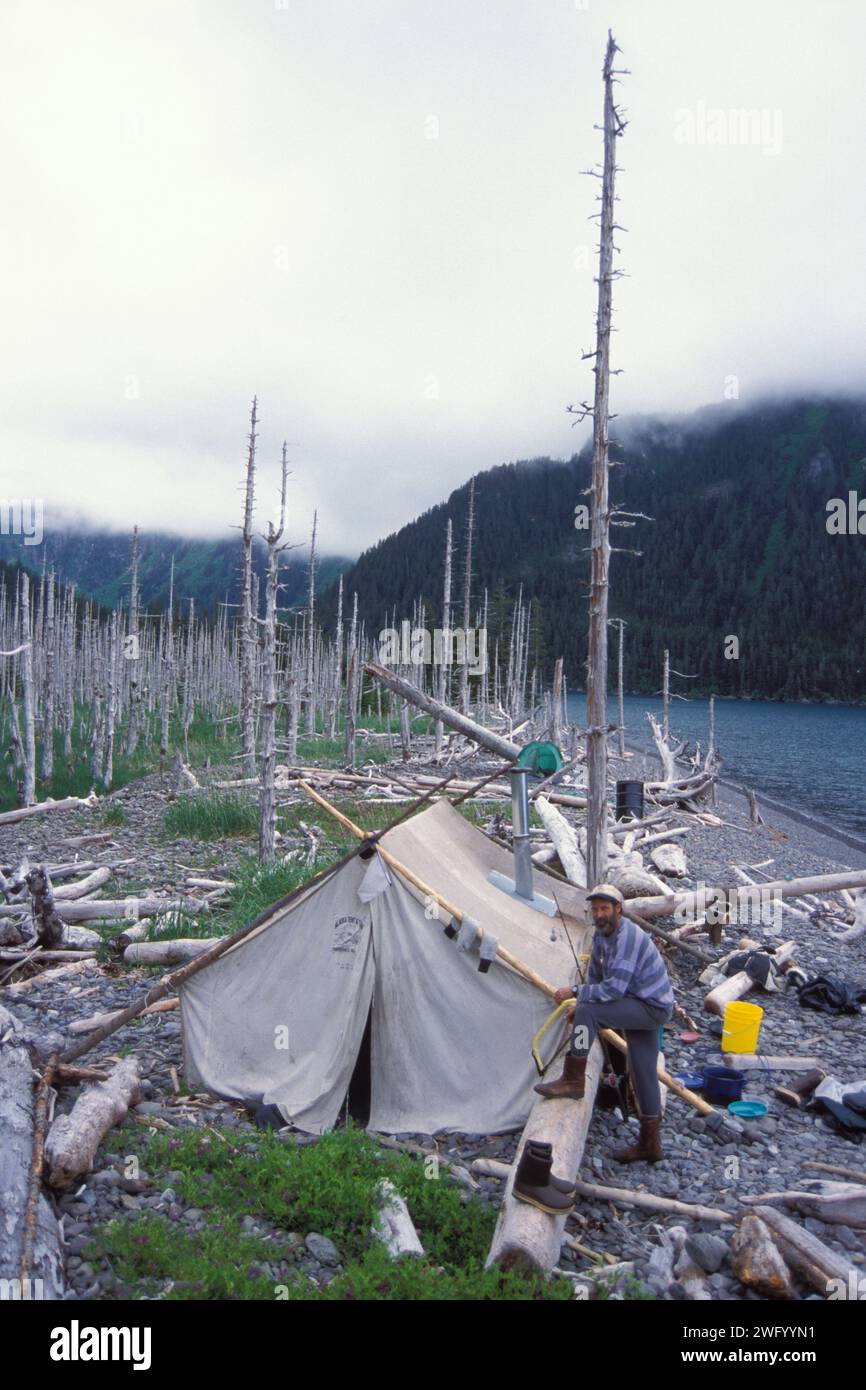 Paul Splan in a wall tent camp in Aialik Bay, Kenai Fjords National ...