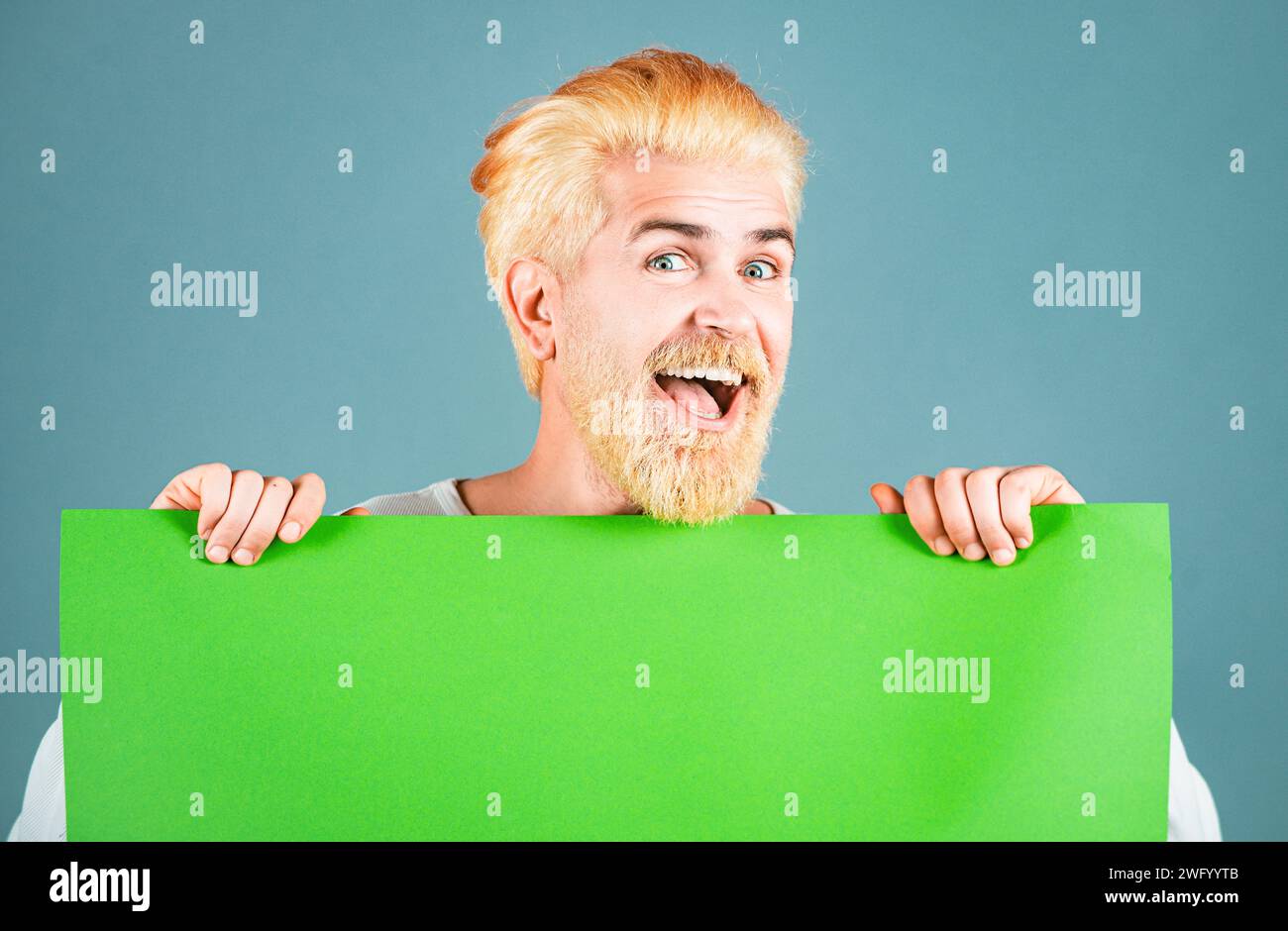 Man holding big sign board. Red head man holding a banner. Sheet ...