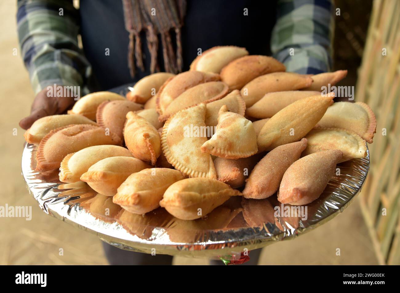 Dhaka. 2nd Feb, 2024. A vendor displays a type of Pitha for sale during ...