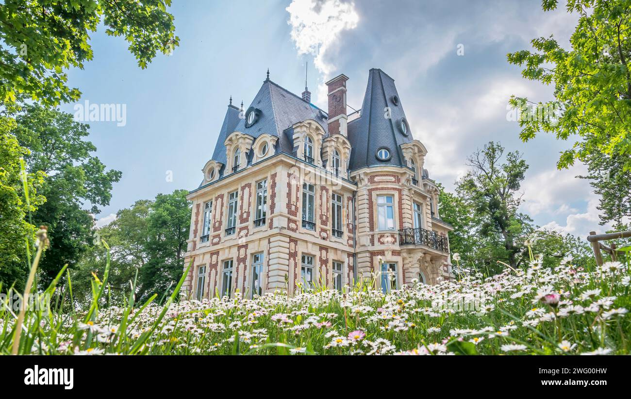 An ancient castle with dual towers set against a picturesque flower ...