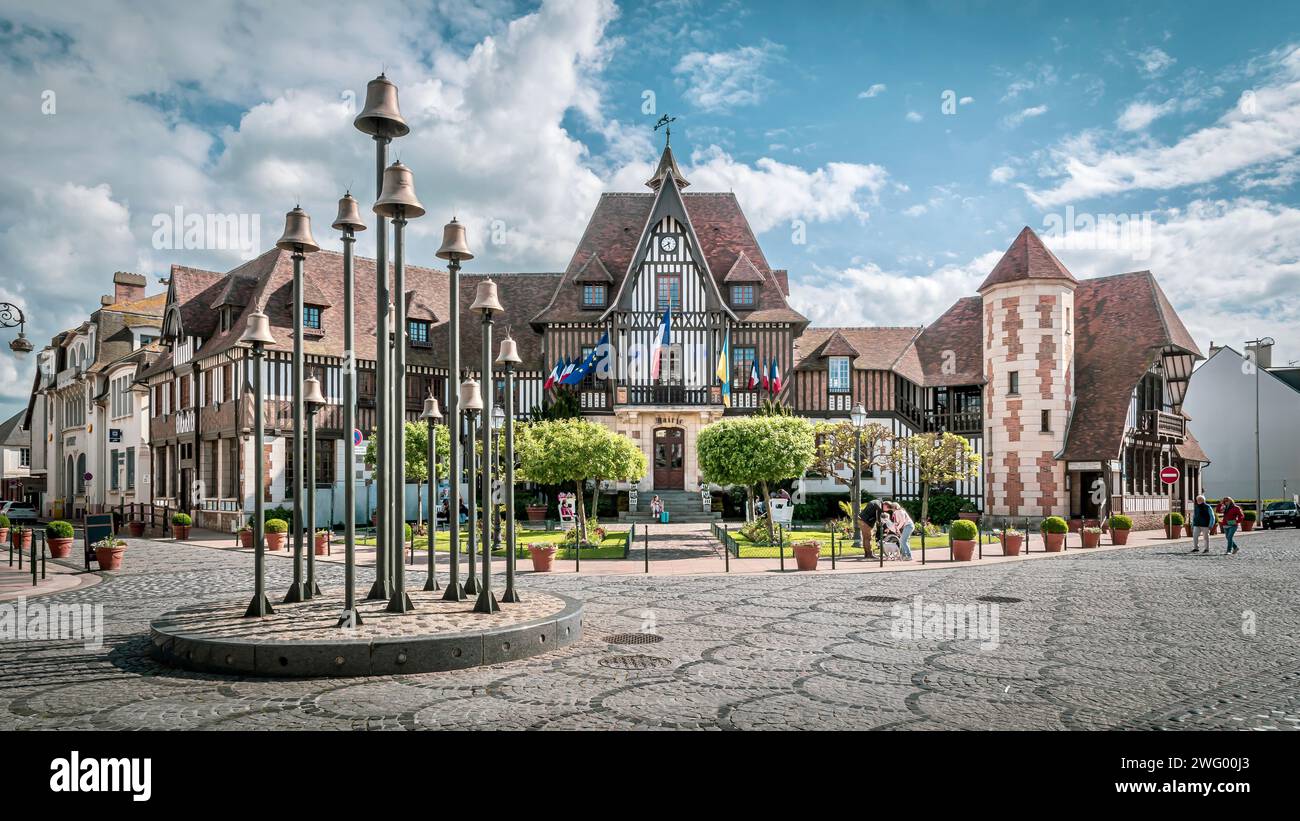 A town square surrounded by buildings with multiple flags on poles ...