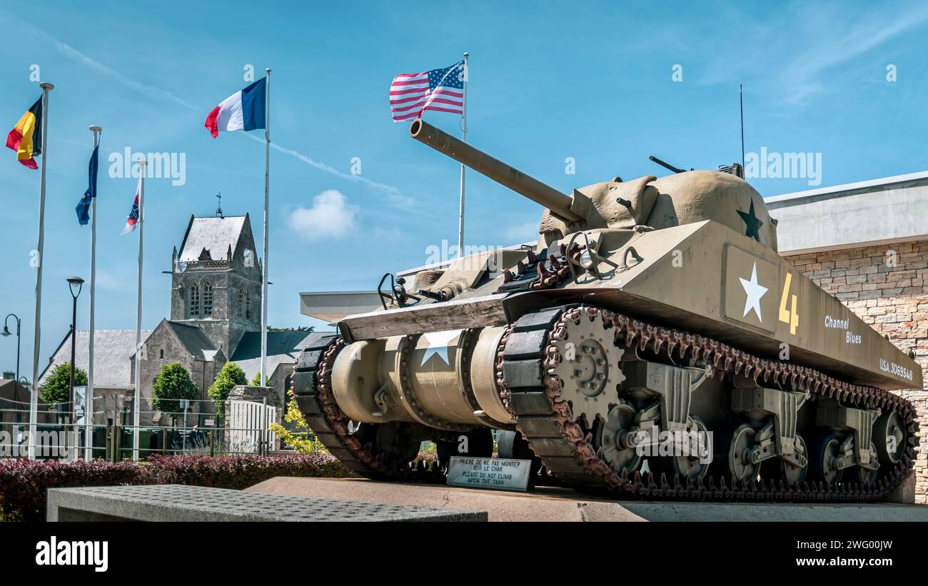 A miniature tank with a flag attached, stationed next to a tiny ...