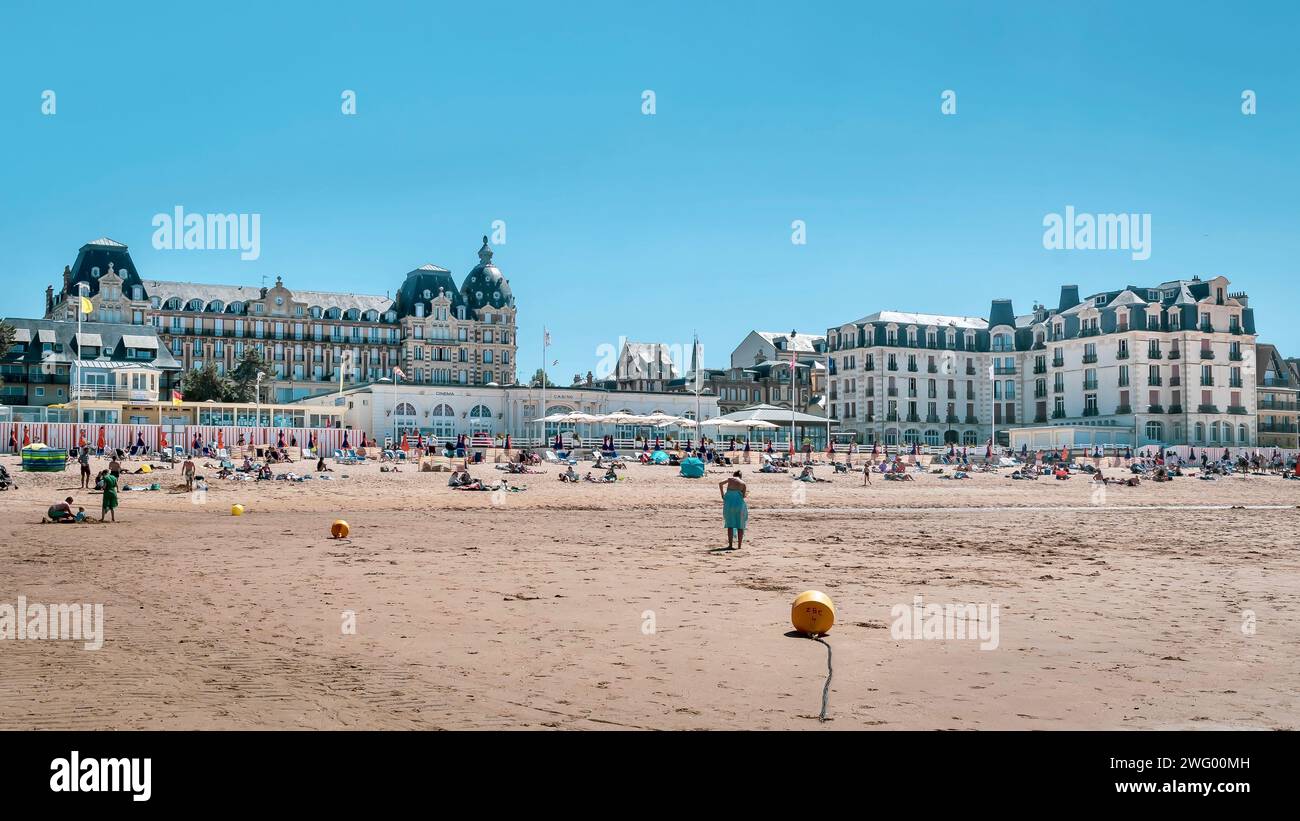 Some people enjoying beach activities in the sandy shore Stock Photo ...
