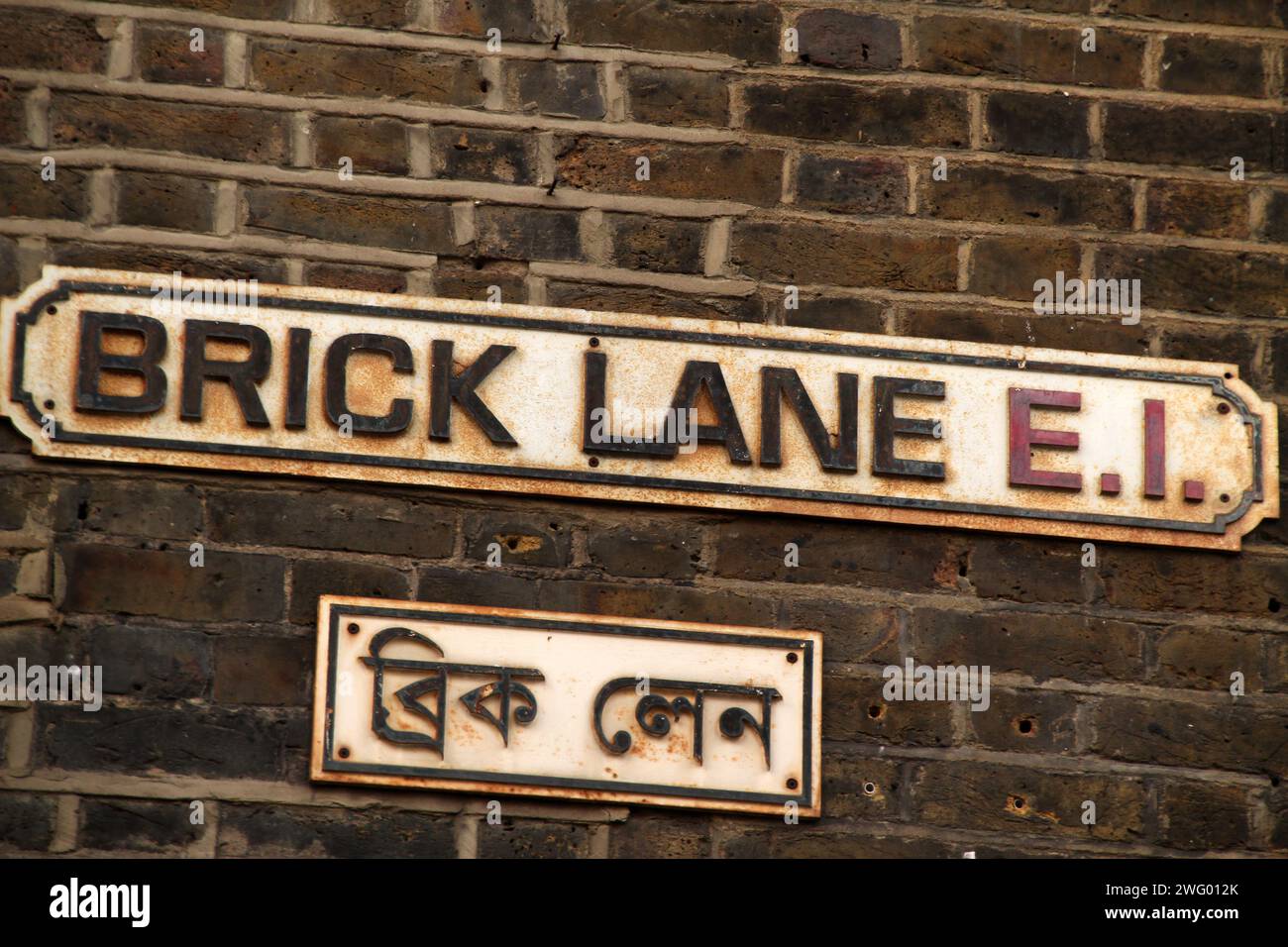 A vintage sign hanging on a brick building on a street in Shoreditch ...