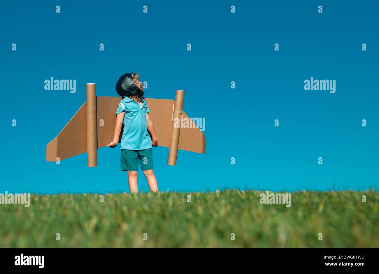 Happy child playing with toy jetpack. Kid pilot having fun outdoor ...