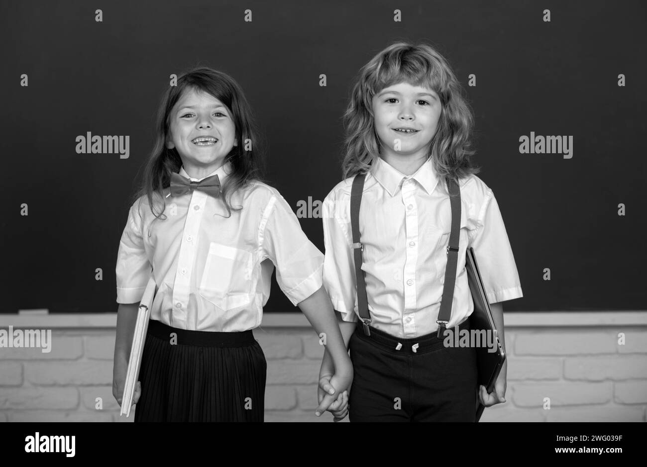 Friendly classmates in school uniform at lesson. Schoolkids and ...