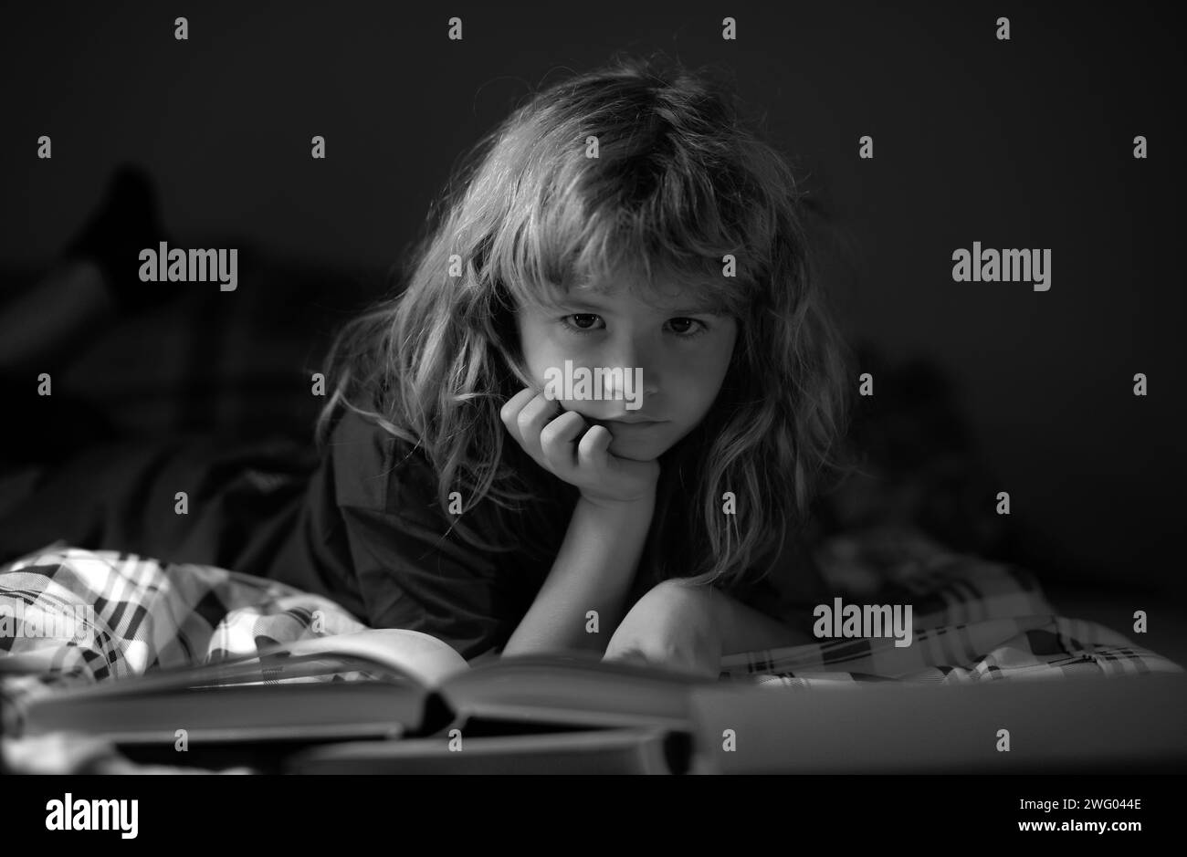 Children reading book in bed Black and White Stock Photos & Images - Alamy