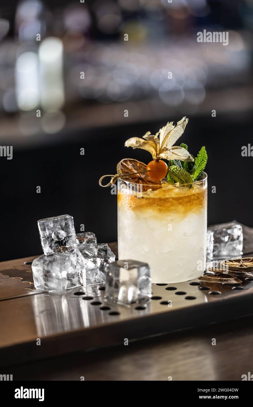 Exotic Mai Tai cocktail drink decorated with physalis and mint on the ...