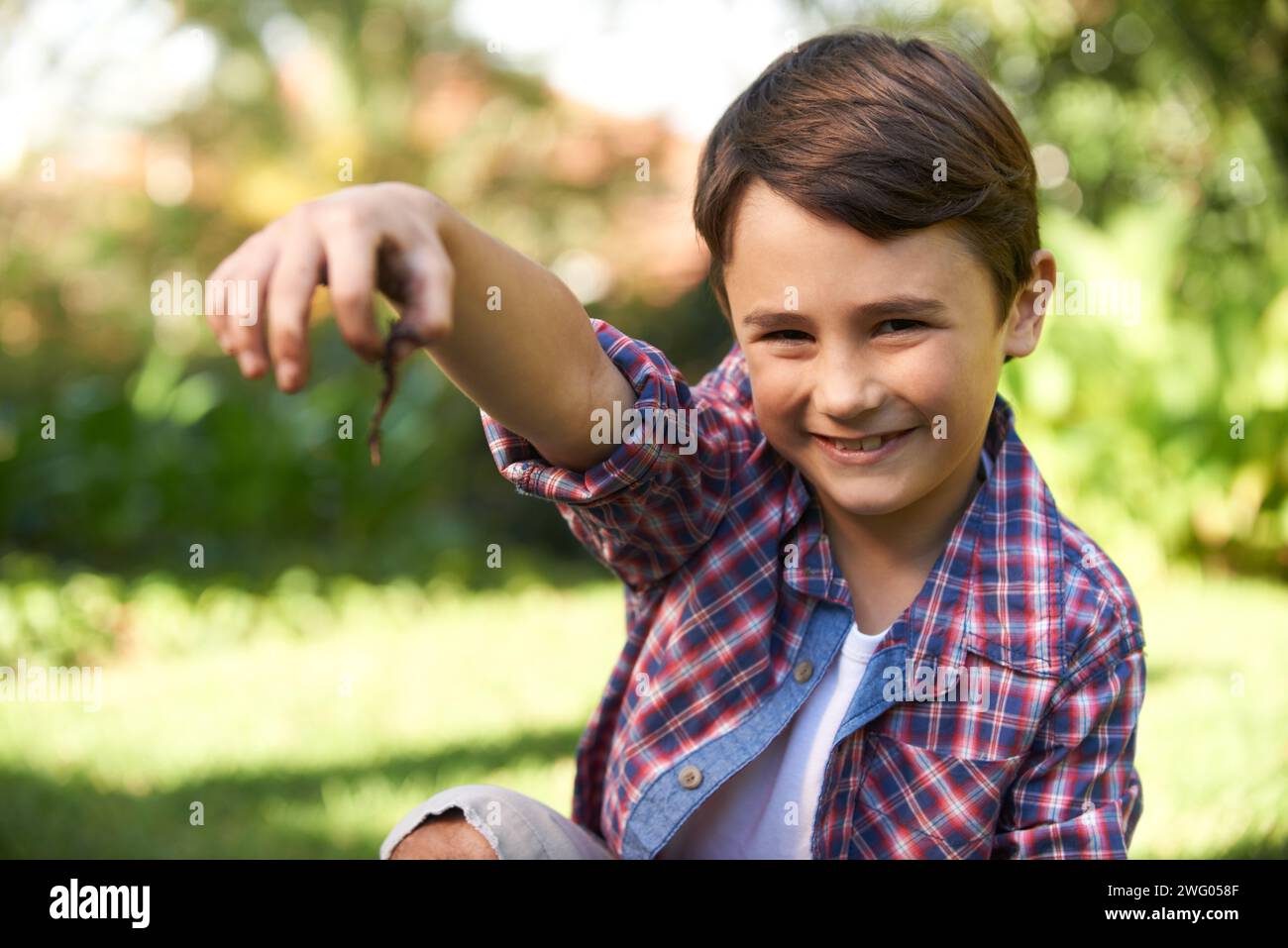 Boy, smile and portrait holding a worm in a garden for fun learning ...