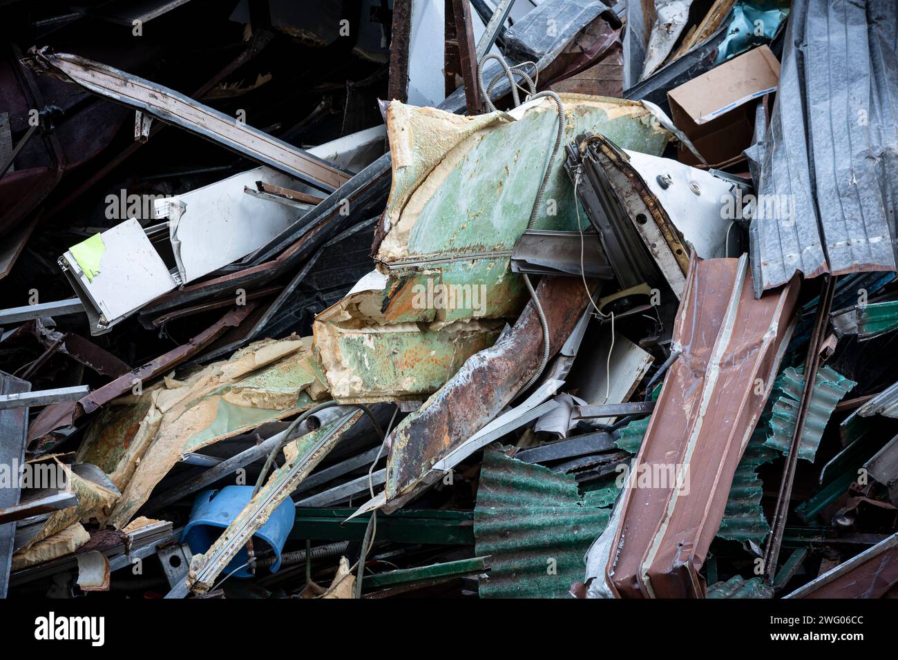 Close-up of a dense pile of mainly broken scrap metal, torn insulation ...