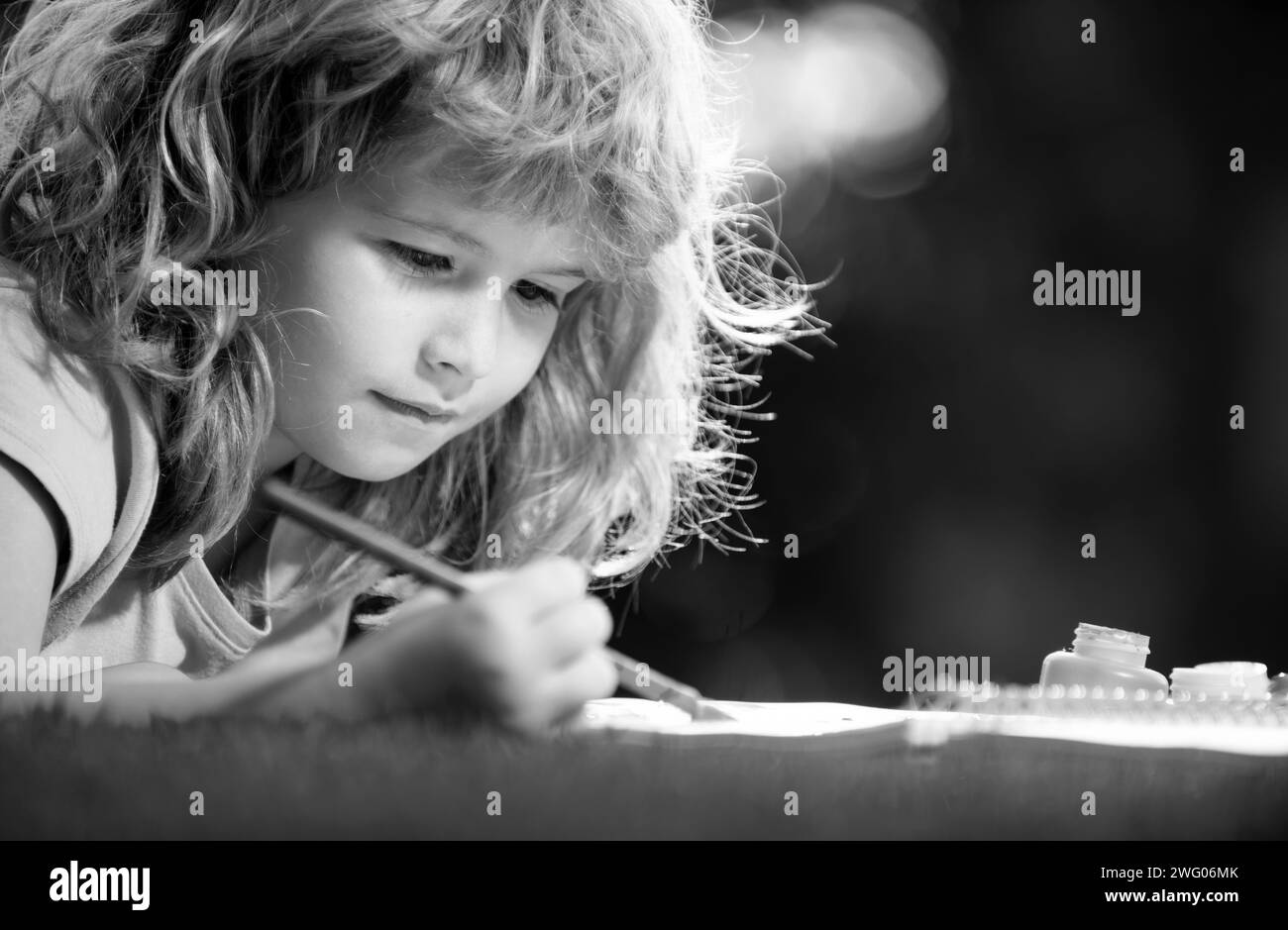 Kids painting with paints color and brush in park outdoor. Children ...