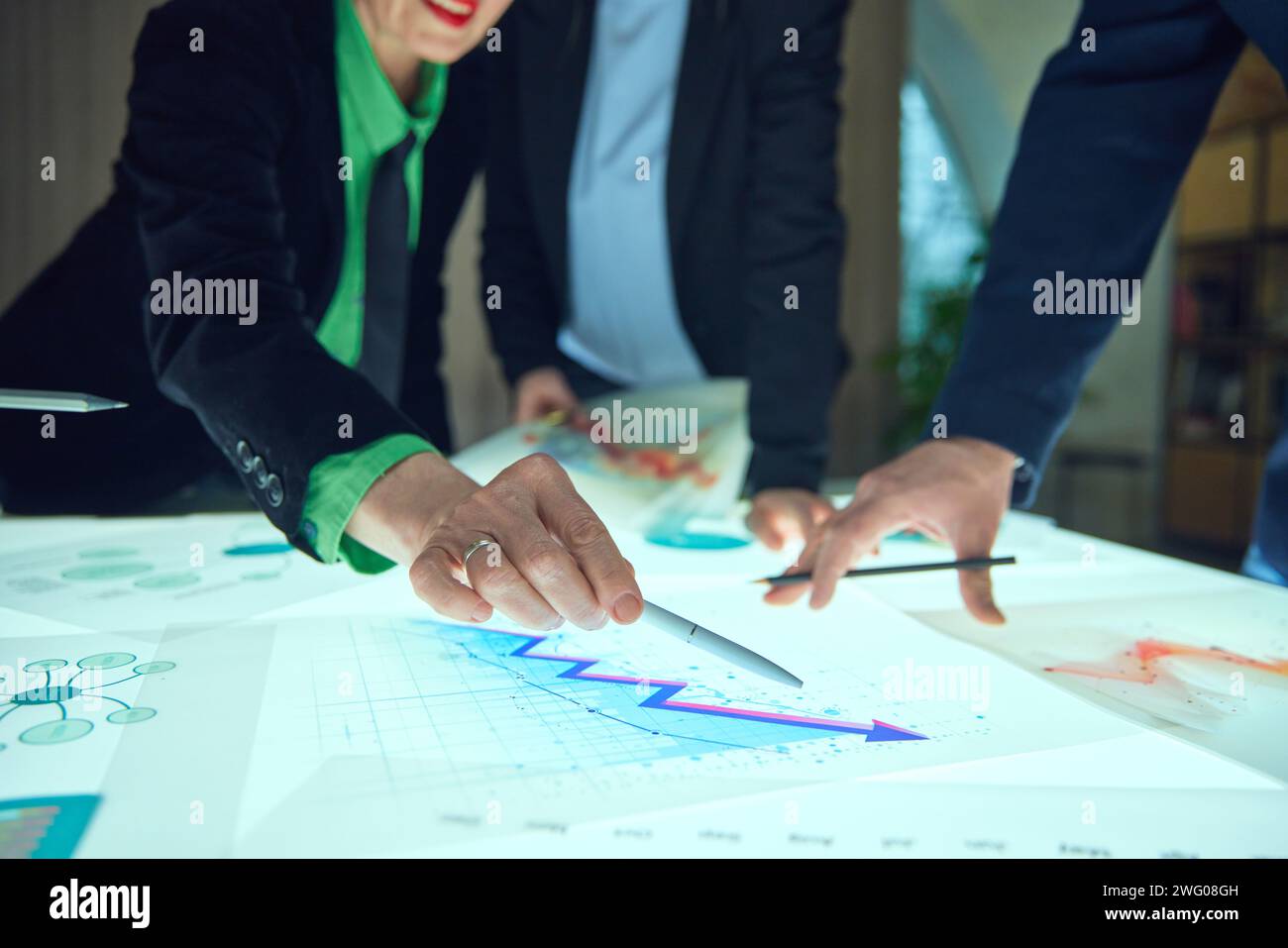 Group of employees working with analytical papers, checking graphs and ...