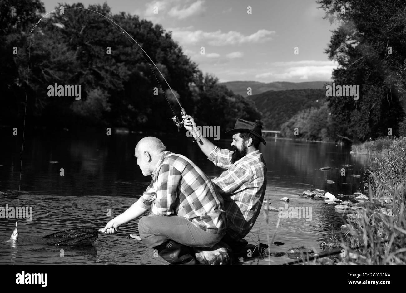 Senior men friends fishing Black and White Stock Photos & Images - Alamy