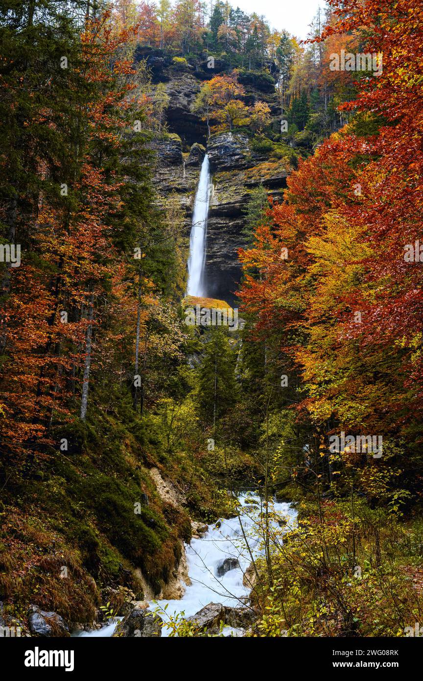 Rippling stream and tumbling waterfall in the mountain with rocks in ...