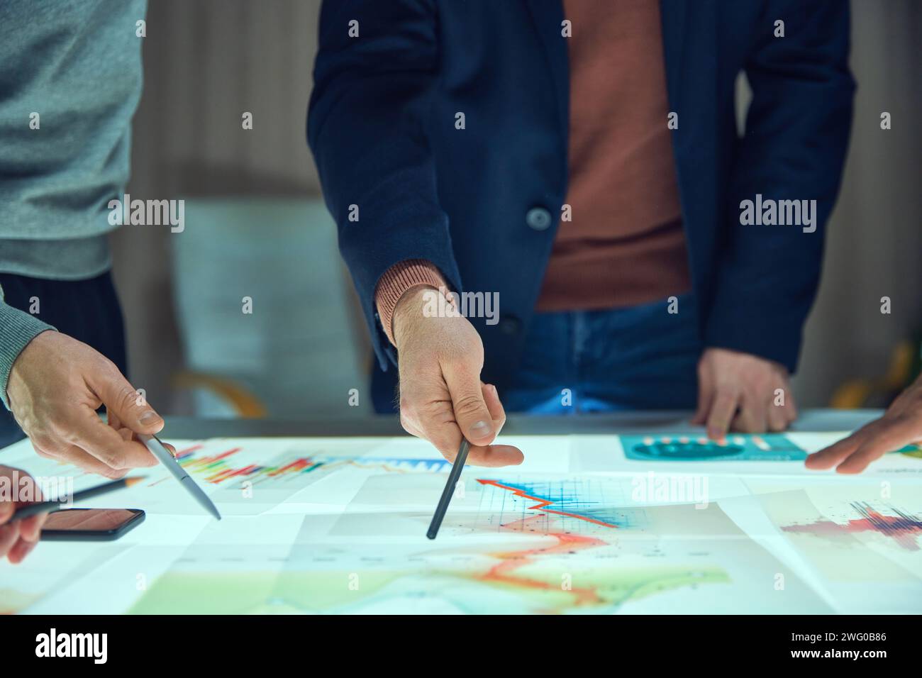 Pointing on important moments. Business people working on startup ...