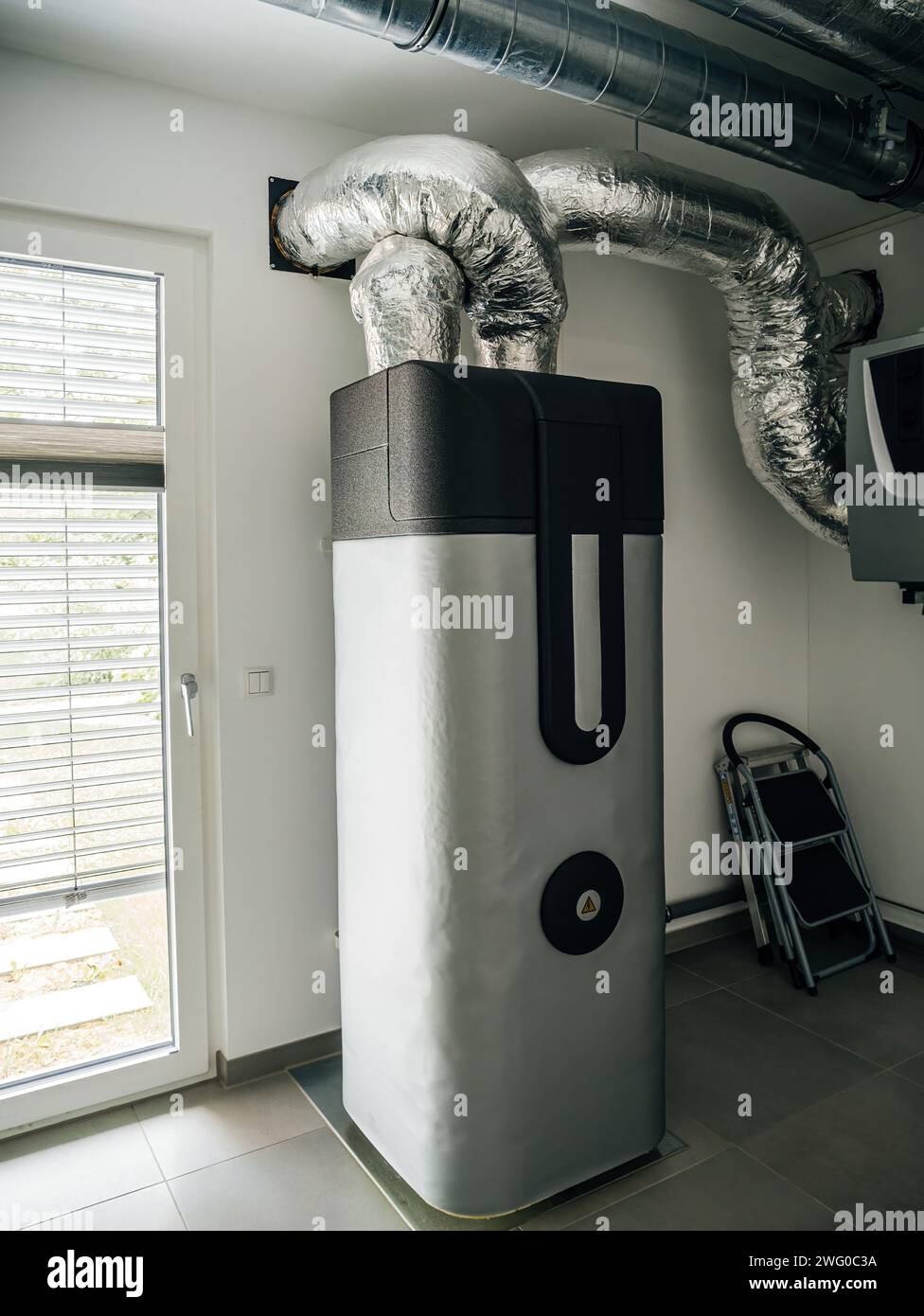 Residential heating and ventilation system with large water tank and ...