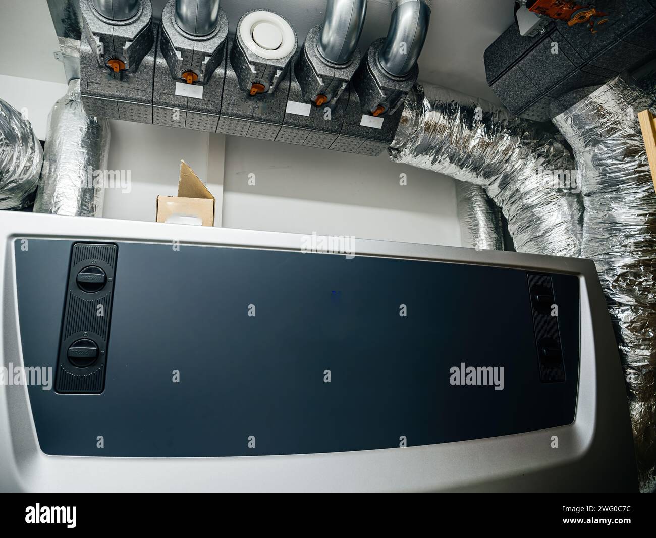 A high-tech central heating ventilation system installed in a clean ...