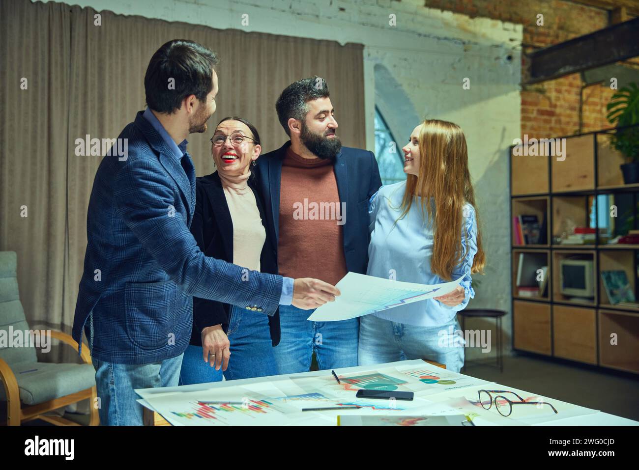 Successful work and cooperation. Employees greeting each other with ...
