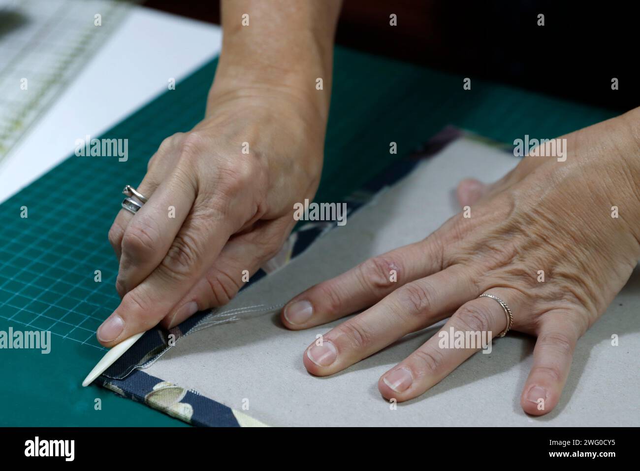 Woman creating quilt in her studio Stock Photo - Alamy