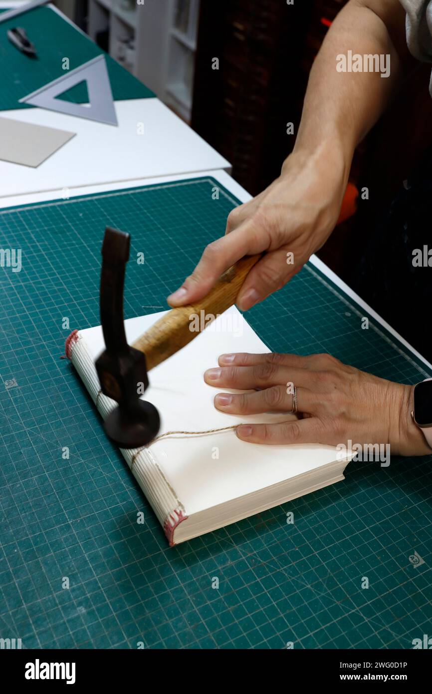 Person using hammer to break paper Stock Photo - Alamy