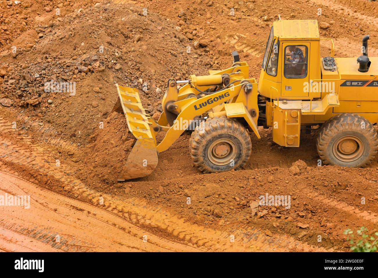 Excavator digging the land Stock Photo - Alamy