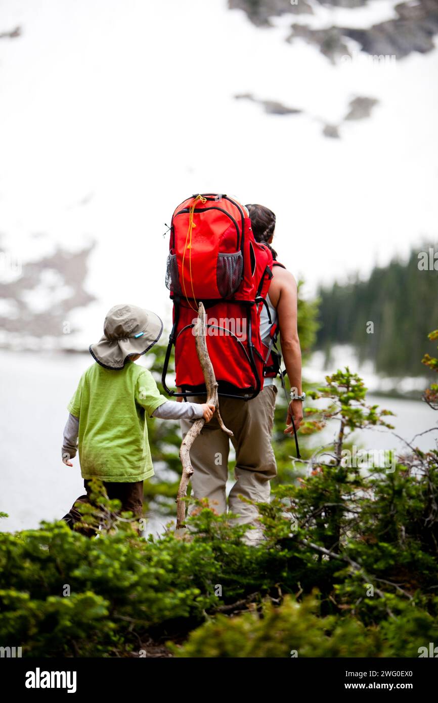 A mother carries her 6 month old son in a baby hiking backpack Stock ...