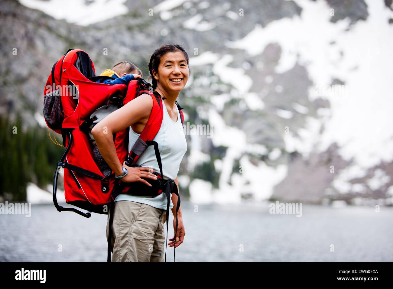 A mother carries her 6 month old son in a baby hiking backpack Stock ...