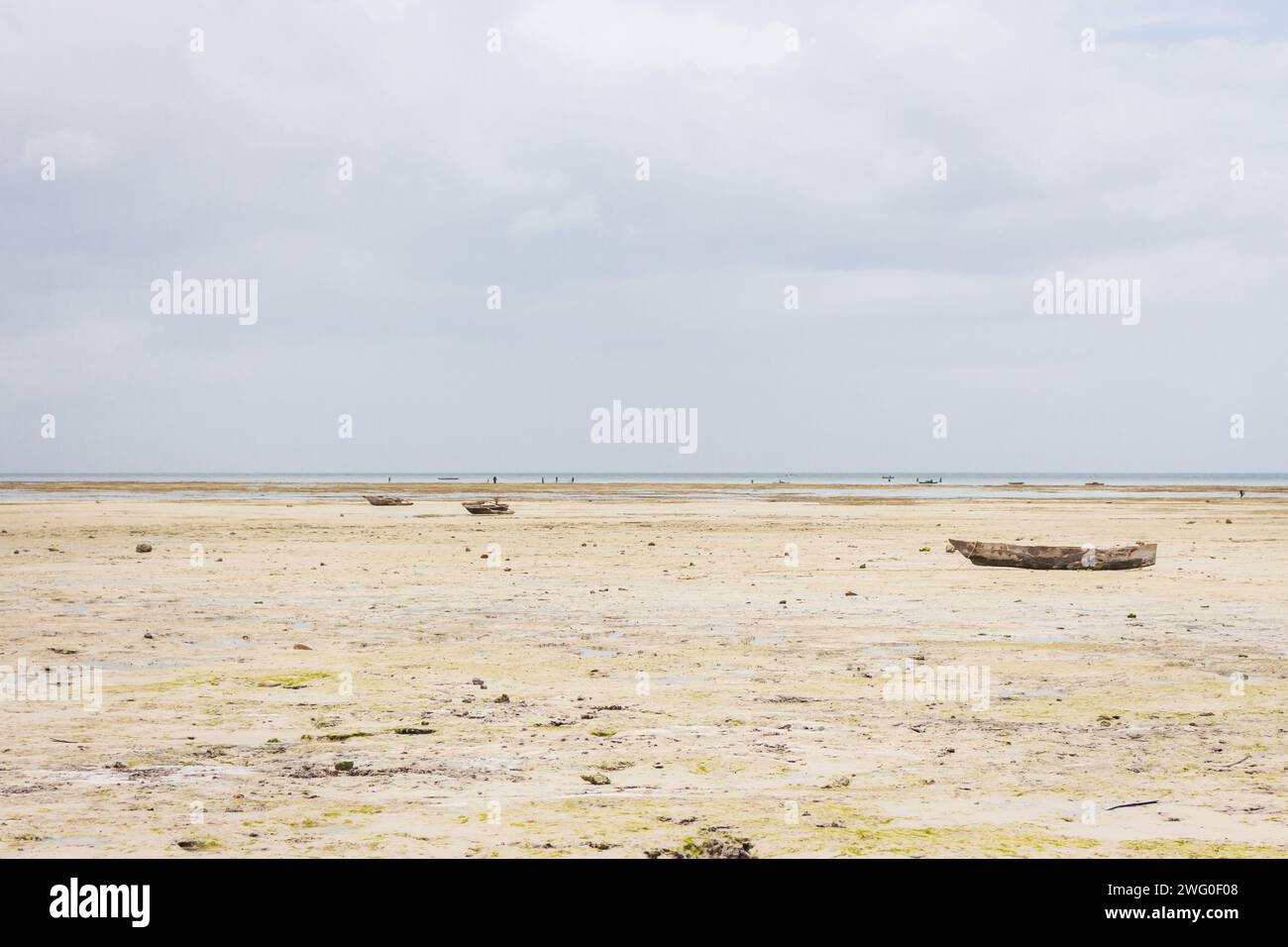 Wooden boats on low tide, toned. Zanzibar beach with old nautical ...