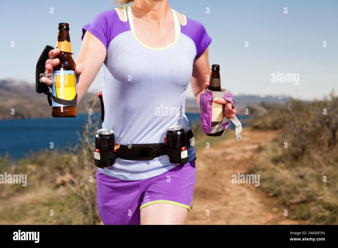 An Athletic Women Runs With Session Beers For Hydration Stock Photo - Alamy