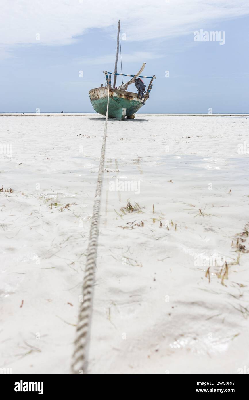 Rusty boat anchored at the beach. Tropical low tide landscape with ...