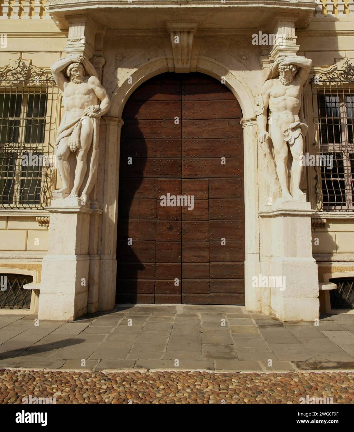 Ancient entrance with statues of a palace in Mantua, Lombardy, Italy ...